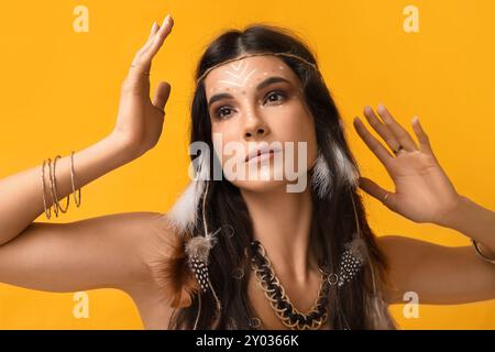 Beautiful female shaman on yellow background Stock Photo - Alamy