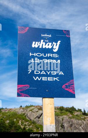 The wharf hours sign at Quidi Vidi fishing village in St. John's ...