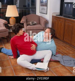 Couple practicing Lamaze breathing techniques at home before baby's ...