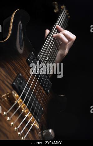 A shallow focus shot of a person playing an electric guitar Stock Photo ...