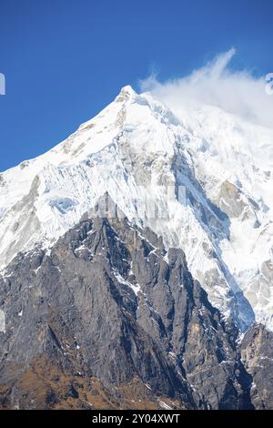 A vertical shot of a mountainous region covered by snow during the ...