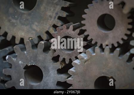 Interlocking gear wheels in front of a black wall Stock Photo - Alamy