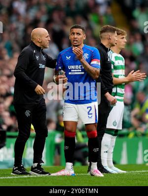 Rangers' James Tavernier (left) speaks to referee Don Robertson during ...