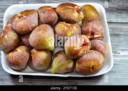 A plate of figs parchment fruit isolated on wooden background, fig is ...
