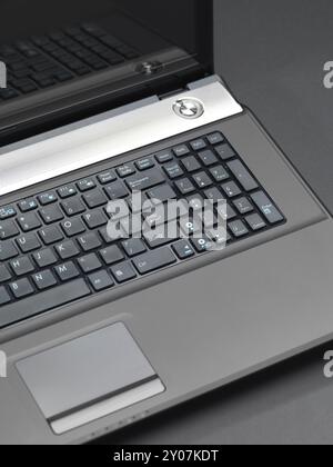 Close-up of a section of a gray laptop keyboard. The image shows the ...