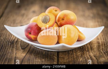 A selective focus shot of Apricots and Peaches on a wooden table Stock ...