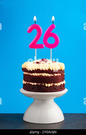 Birthday cake with candle number 26 - Blue background Stock Photo - Alamy
