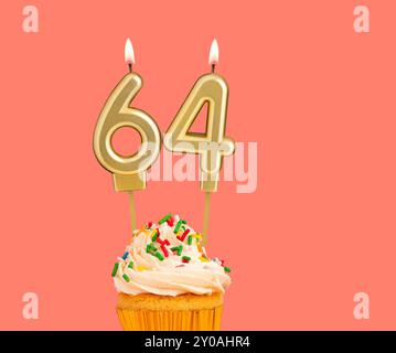 Birthday candle number 64 - Cupcake on white background Stock Photo - Alamy