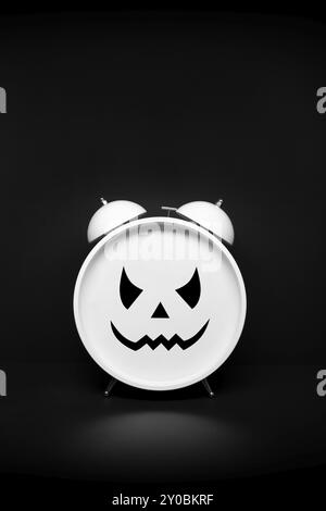 Retro Clock with scary face on dark background Stock Photo - Alamy