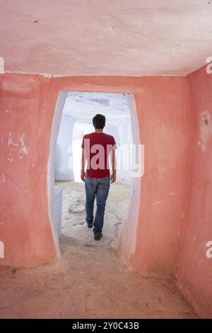Man walking inside red coloured hot air balloon viewed from the side of ...