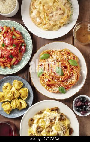 Various olives on rustic wooden background Stock Photo - Alamy