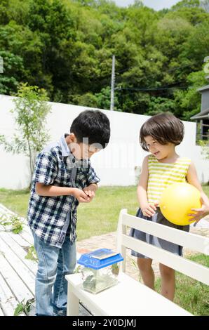 Children playing with ball on bench Stock Photo - Alamy