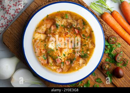 Castilian soup with vegetables, bread croutons and egg. Top view table ...