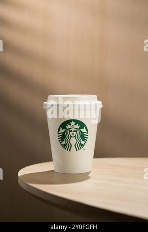 A Starbucks coffee cup sits on a metal fence in Pittsburgh on Monday ...