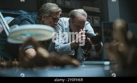 Modern archaeological lab: Two archaeologists or scientists photograph ...