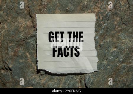 Get the facts message written on ripped torn paper piece with cardboard ...