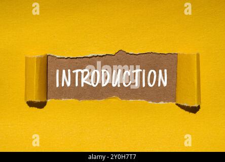 Introduction message written on ripped yellow torn paper piece with ...