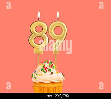 Cupcake with birthday candle - Candle number 89 Stock Photo - Alamy