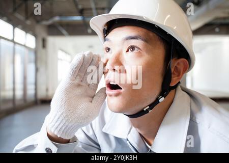 Giving instructions by the hand. Male worker is on the location with ...