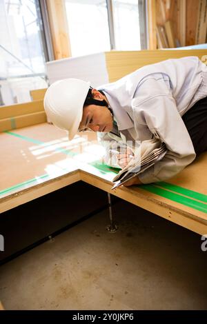Site foreman checking a house under construction Stock Photo - Alamy