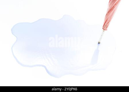 Light blue puddle and a pink umbrella Stock Photo - Alamy