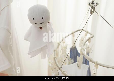 Indoor drying laundry and a paper doll Stock Photo - Alamy