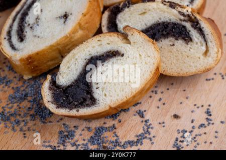 Fresh bun with poppy seed filling on the table, sweet flour dessert ...