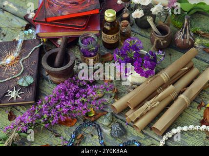 Magical still life with spells, herbs, potion ingredients, wax candles ...