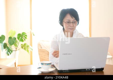 Senior woman facing personal computer Stock Photo - Alamy