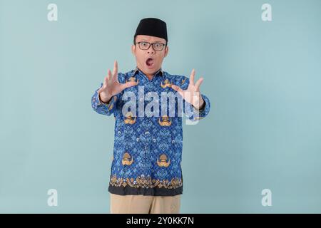 Stressed Indonesian government worker man wearing blue batik uniform ...