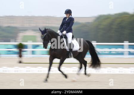 Team USA's Rebecca Hart riding Floratina being watched by a team member ...