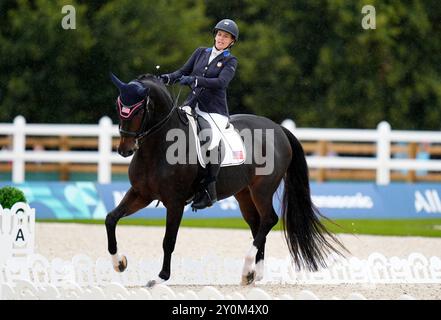 Team USA's Rebecca Hart riding Floratina being watched by a team member ...