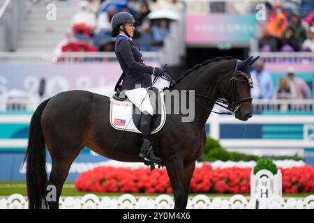 Team USA's Rebecca Hart riding Floratina being watched by a team member ...