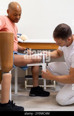Measuring leg for prosthetic fitting, technician using caliper in lab ...