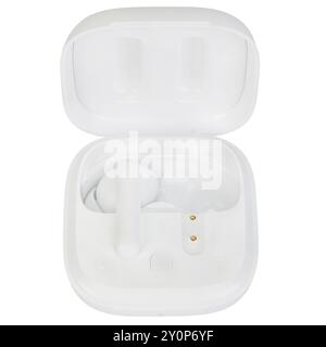 White earbuds in open case on wooden surface. Minimalist design with ...