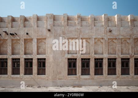 The exterior of a traditional Middle Eastern mud brick building with a ...