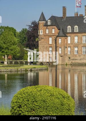 The small lakes surrounded by green trees under a cloudy sky at sunset ...