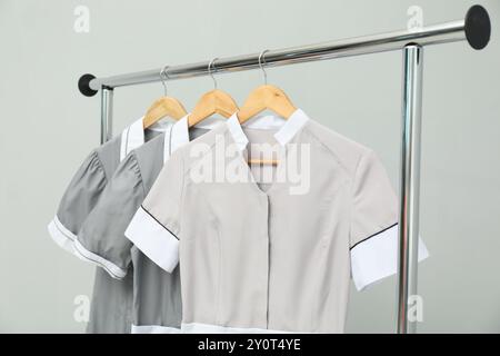 Maids' uniforms on clothing rack against grey background Stock Photo ...
