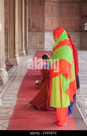 Modestly-dressed woman praying in mosque, Delhi, India Stock Photo - Alamy