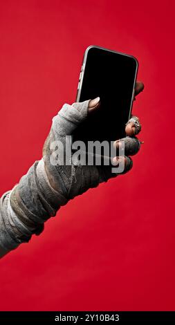 Terrifying hand, monster's hand holding digital smartphone with blank ...
