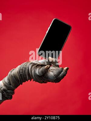 Terrifying hand, monster's hand holding digital smartphone with blank ...