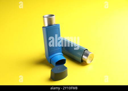 Asthma inhalers on yellow background Stock Photo - Alamy