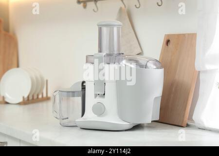 Modern juicer on white marble counter in kitchen Stock Photo - Alamy