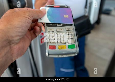 Cropped view of client paying with credit card near african american ...