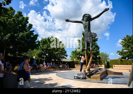 People venerating the statue of the Risen Christ in Medjugorje. The ...
