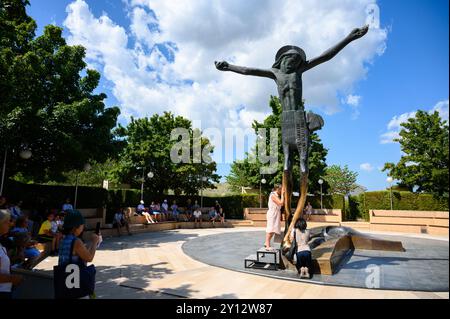 People venerating the statue of the Risen Christ in Medjugorje. The ...