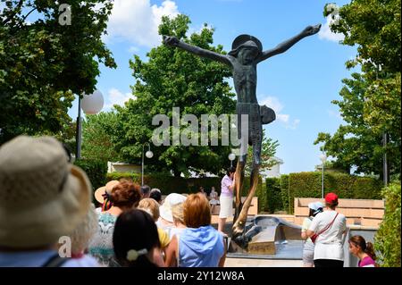 People venerating the statue of the Risen Christ in Medjugorje. The ...