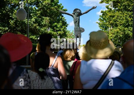 People venerating the statue of the Risen Christ in Medjugorje. The ...
