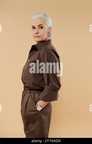 A confident woman stands with poise, showcasing her stylish outfit in a ...