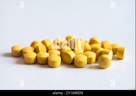 Medical tablets, placed next to each other on a white surface ...